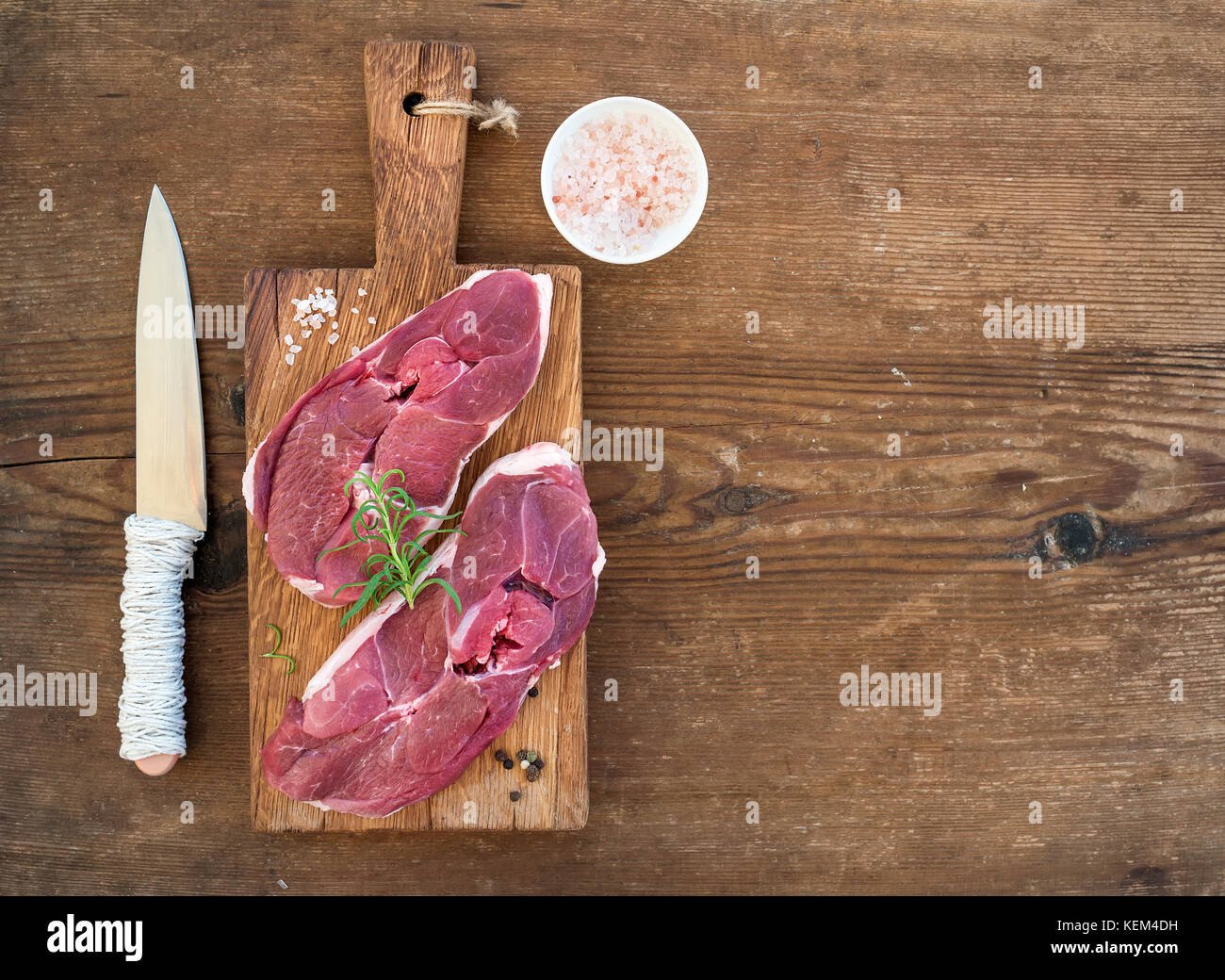 Raw fresh meat lamb entrecote and seasonings on cutting board over ...