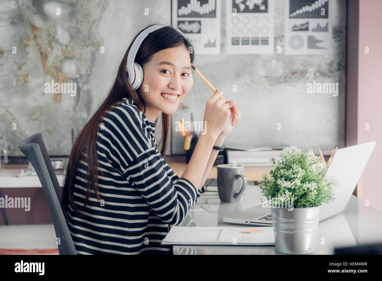 Young asian casual businesswoman arm on desk rest pose with laptop ...