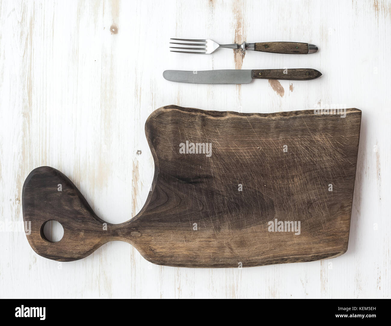 Kitchen-ware set. Old rustic chopping board made of walnut wood, knife ...
