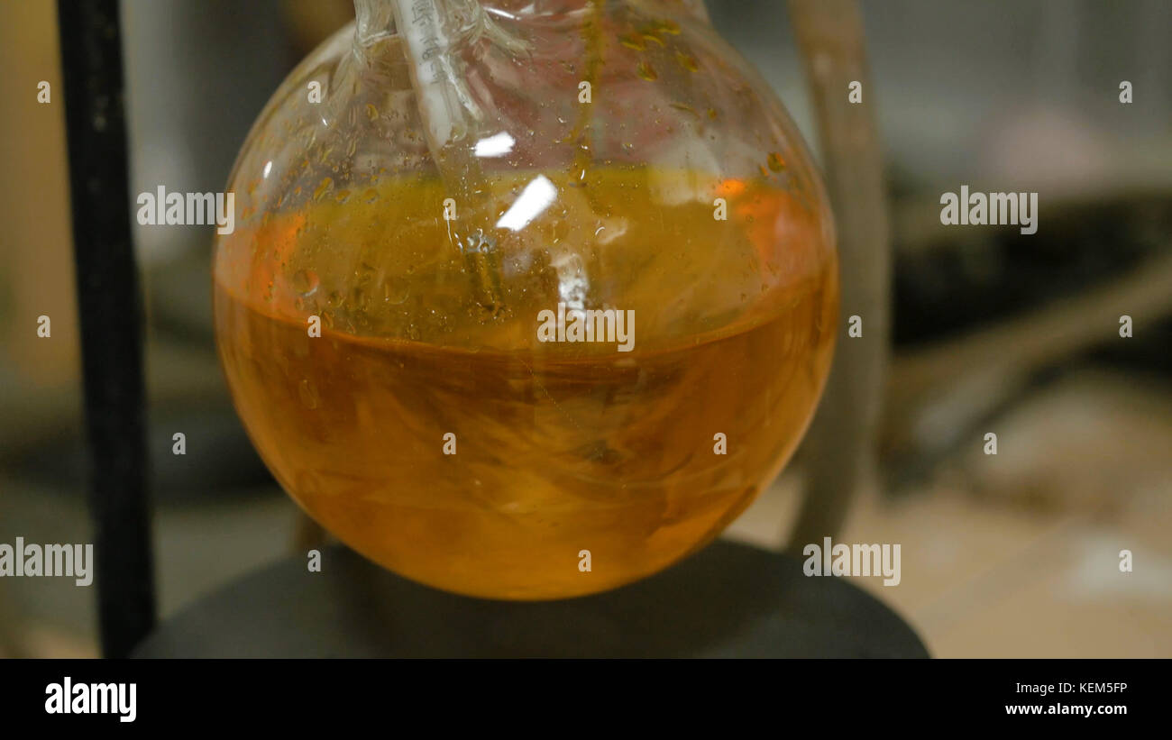 Scientist mixing liquids in flasks in a research lab. Special equipment ...