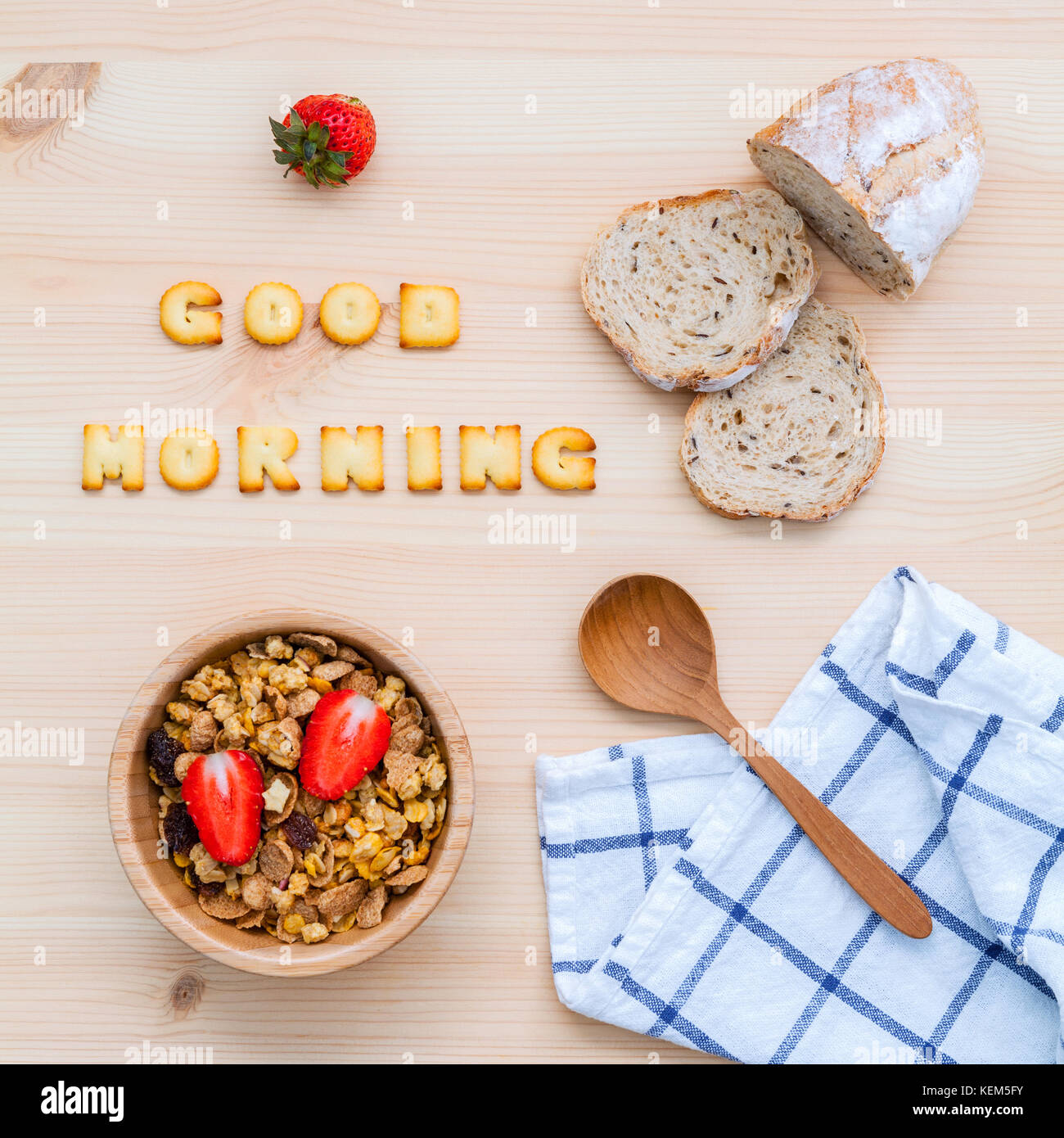Good morning concept - Cereal in wooden bowl with strawberry and wooden ...