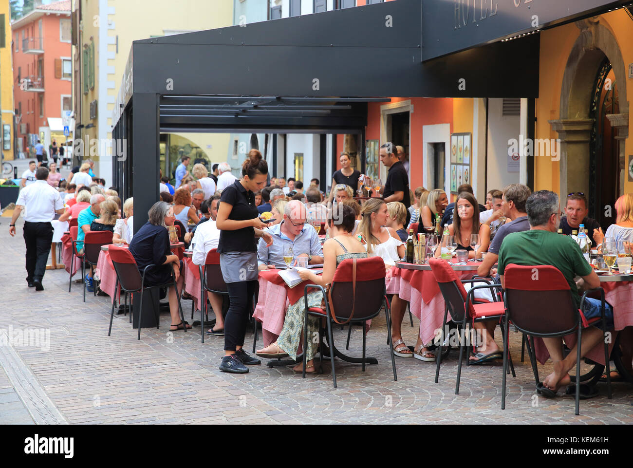 Busy restaurant on a summer's evening in Torbole, on Lake Garda, in ...