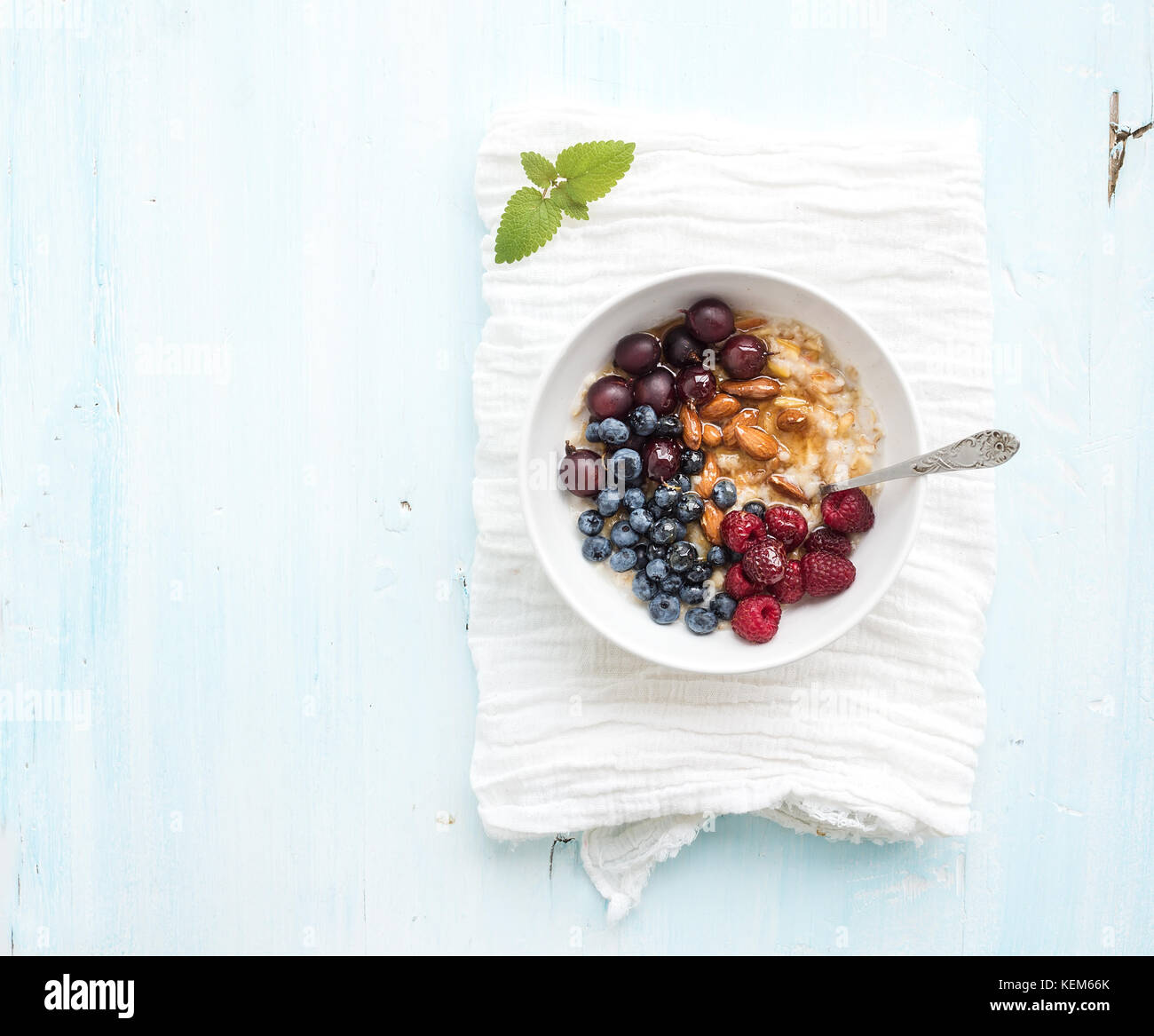 Healthy breakfast set. Bowl of oat porridge with fresh berries, almond ...
