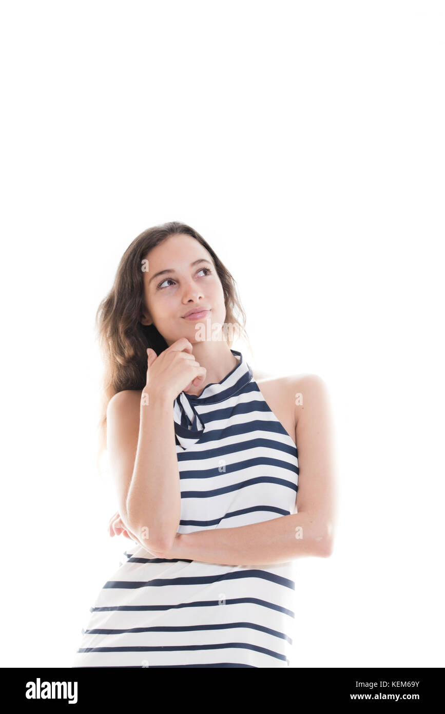 Young pretty woman looking up, finger over face with smiling deciding ...