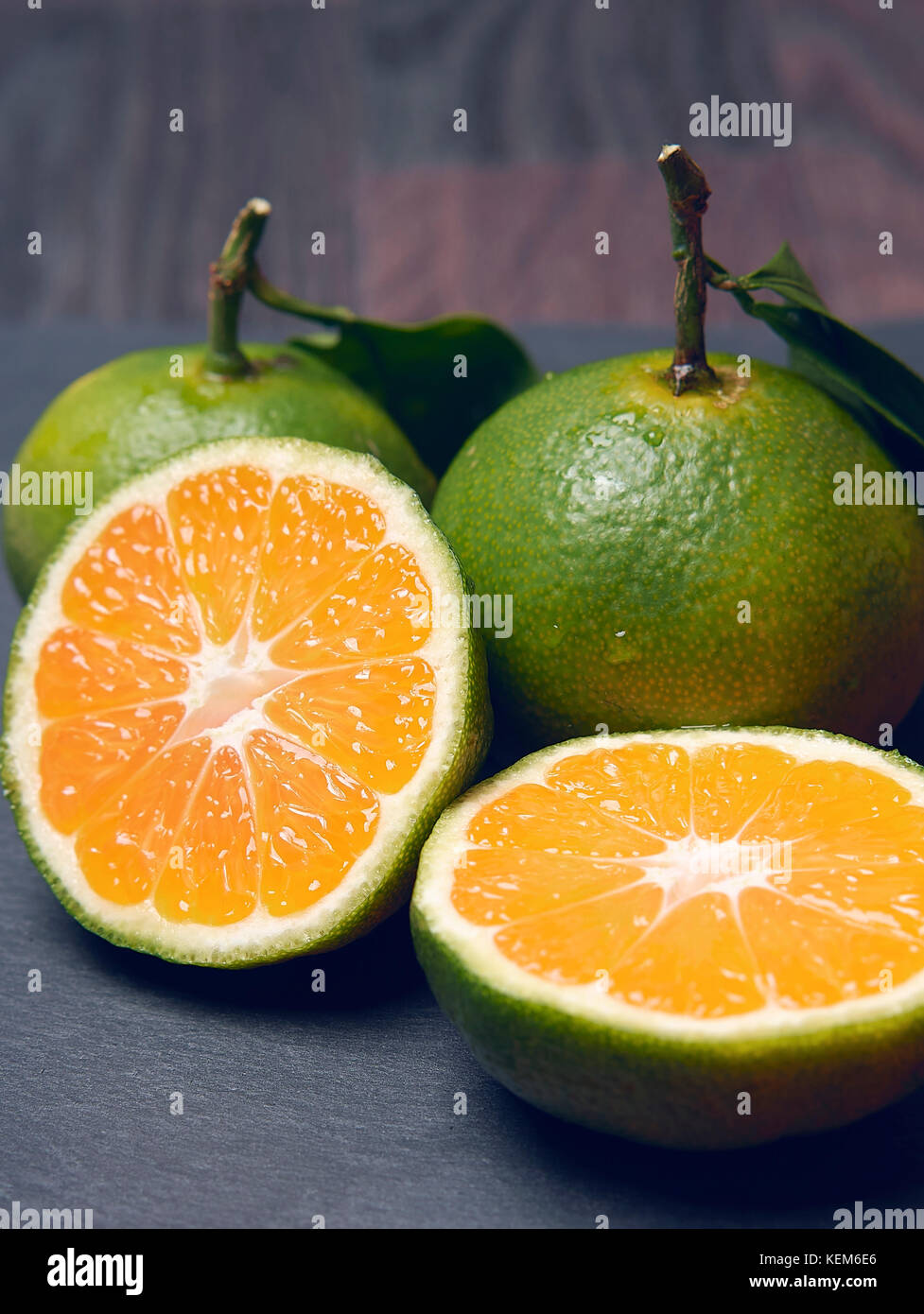 green Mandarin slices on black background Stock Photo - Alamy