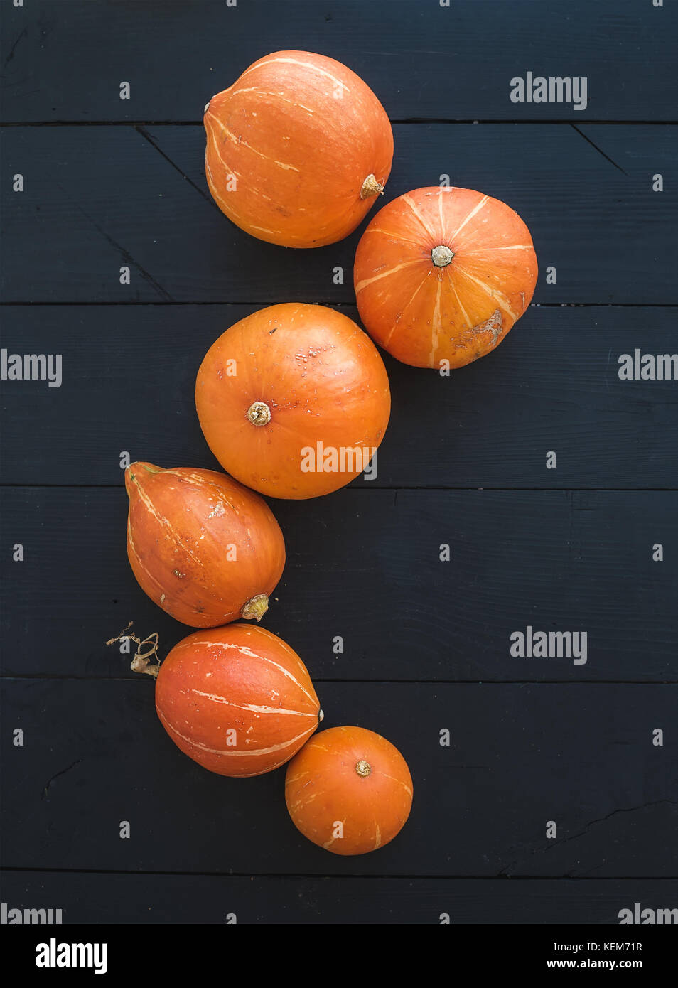 Ripe pumpkins over black rustic wooden backdrop, top view Stock Photo ...