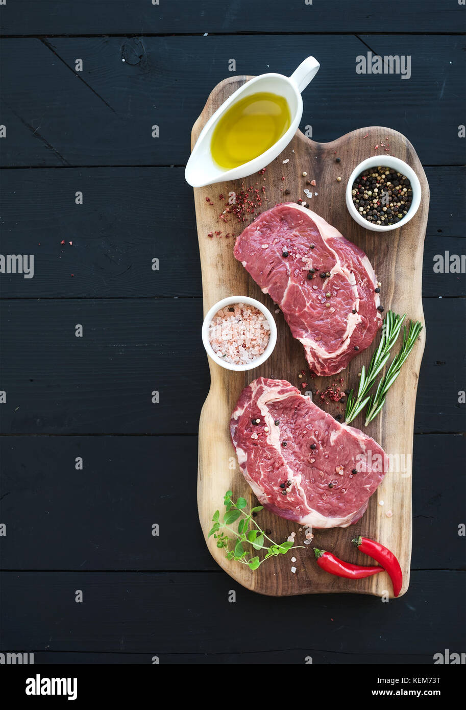 Raw fresh meat Ribeye steak entrecote and seasonings on cutting board ...