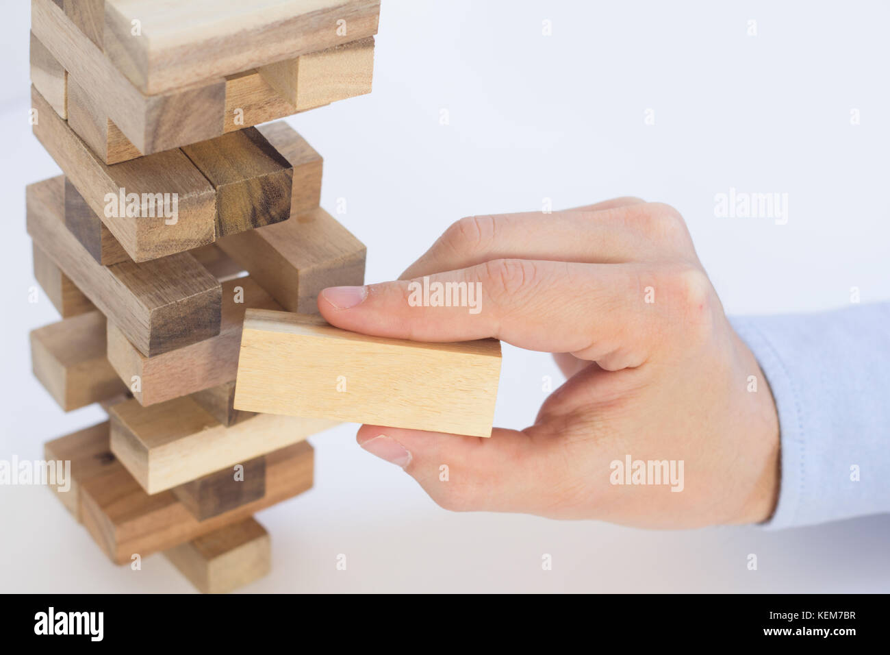 hand building wooden block tower Stock Photo - Alamy