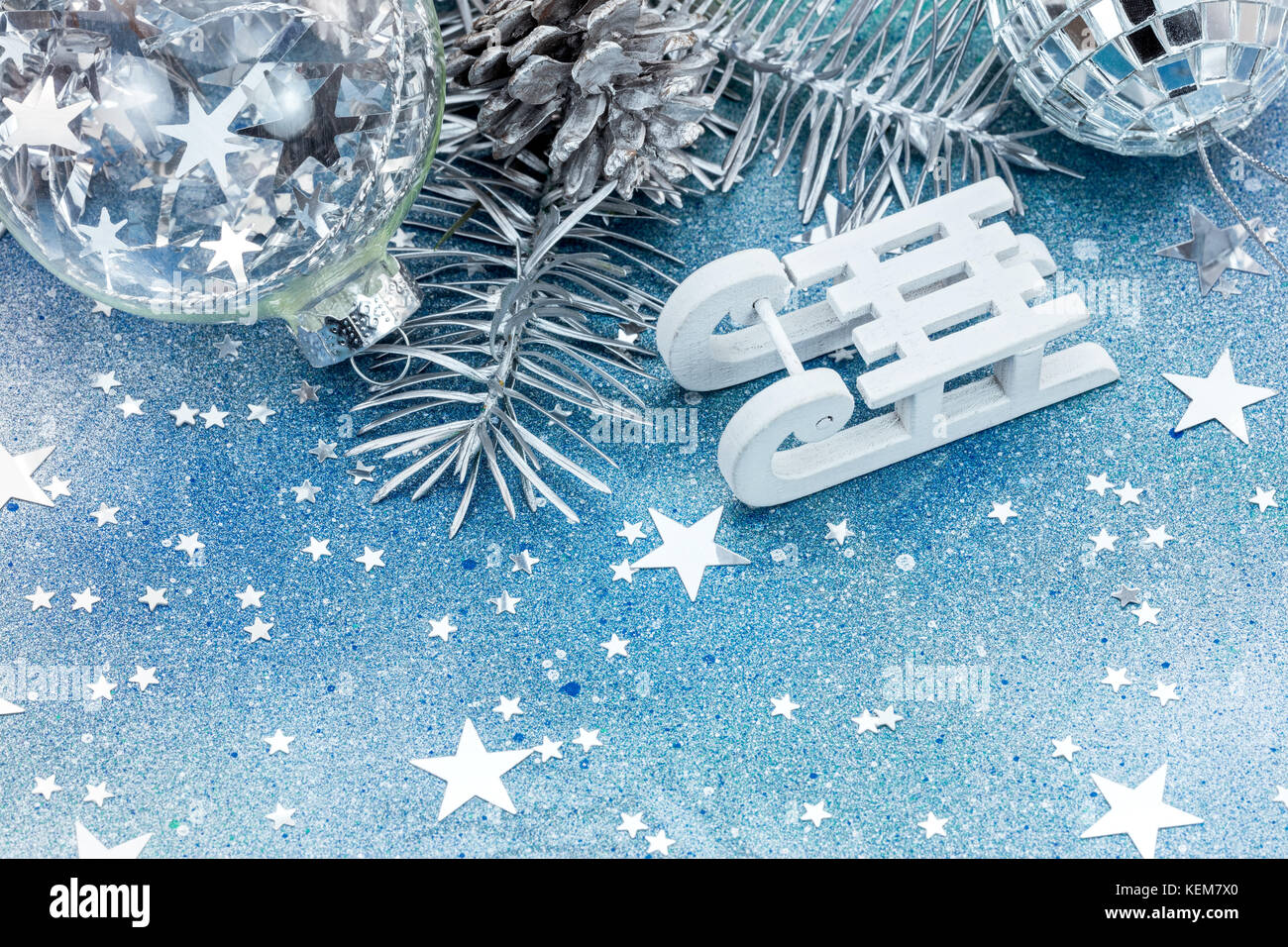 wooden sledge, glass balls, spangle, silver cone and sparkling stars on ...