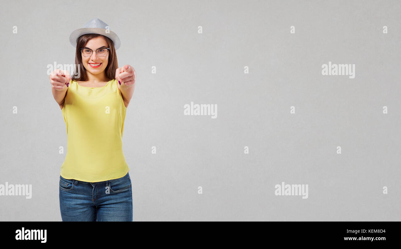 A girl points to a place for text on a gray background Stock Photo - Alamy