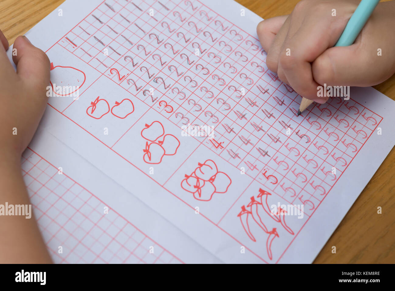 kid learns to write Arabic numerals by following guides Stock Photo - Alamy