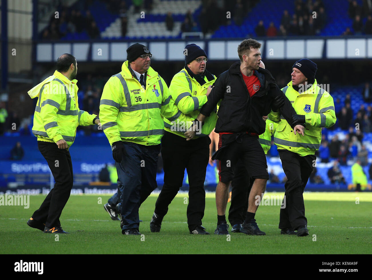 A pitch invader is caught by stewards during the Premier League match ...