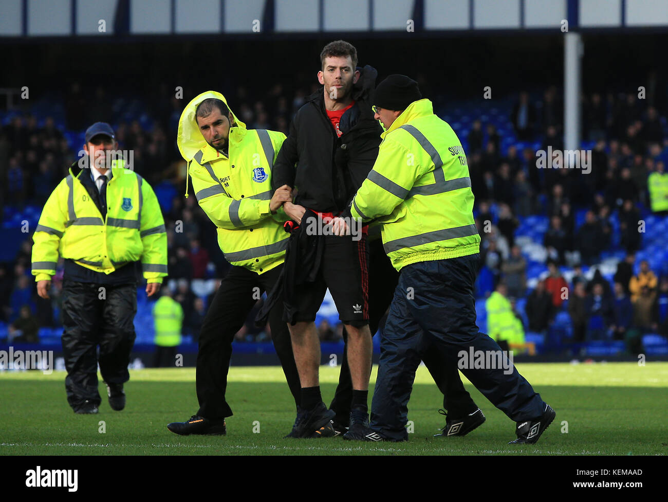 A pitch invader is caught by stewards during the Premier League match ...