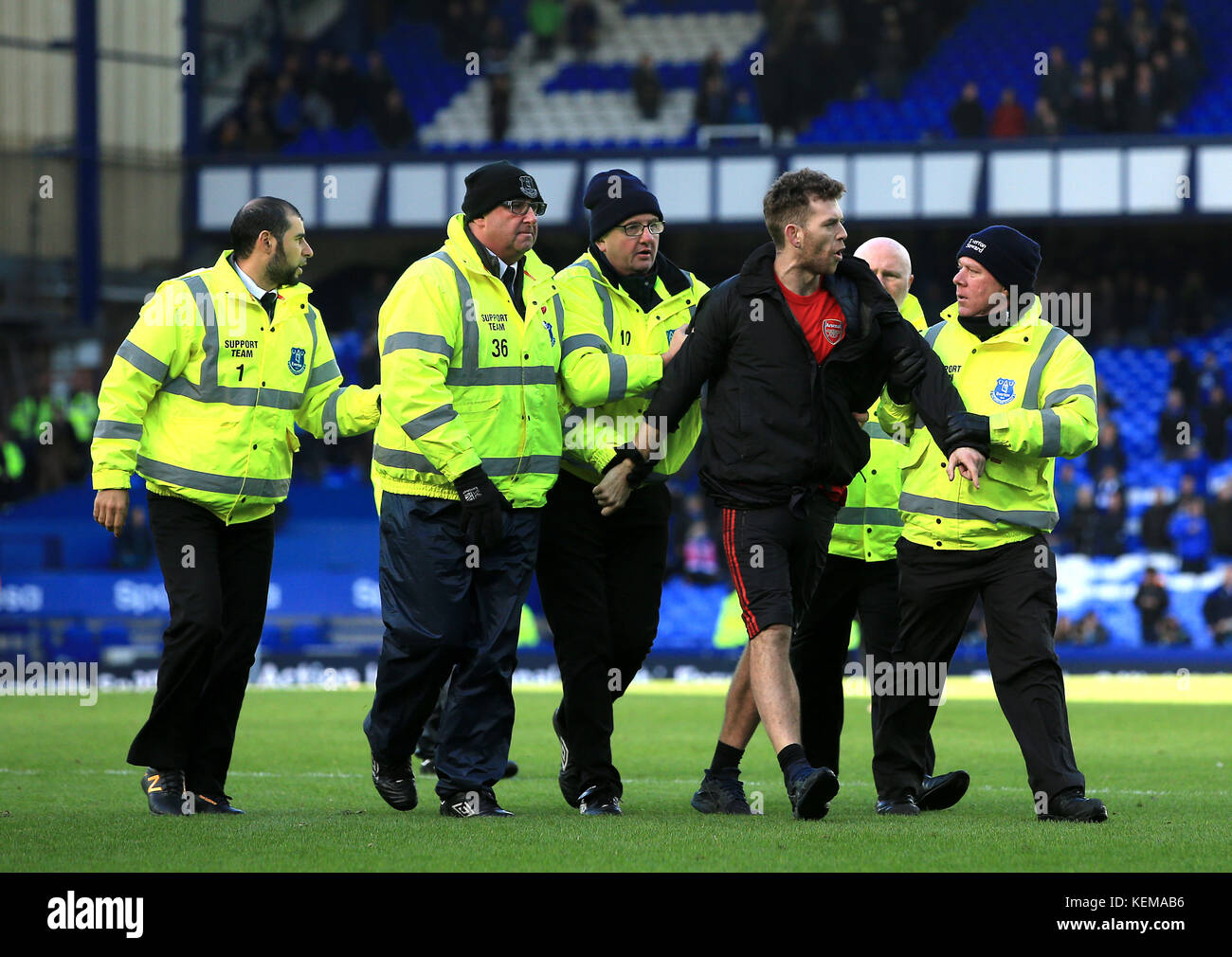 A pitch invader is caught by stewards during the Premier League match ...