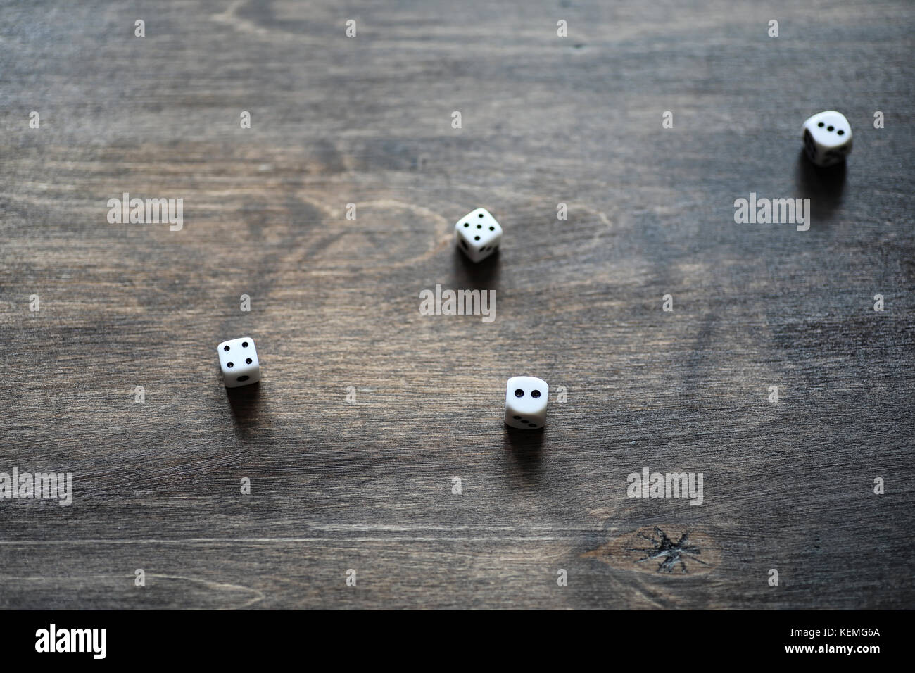 White dices on a brown wooden texture table Stock Photo - Alamy