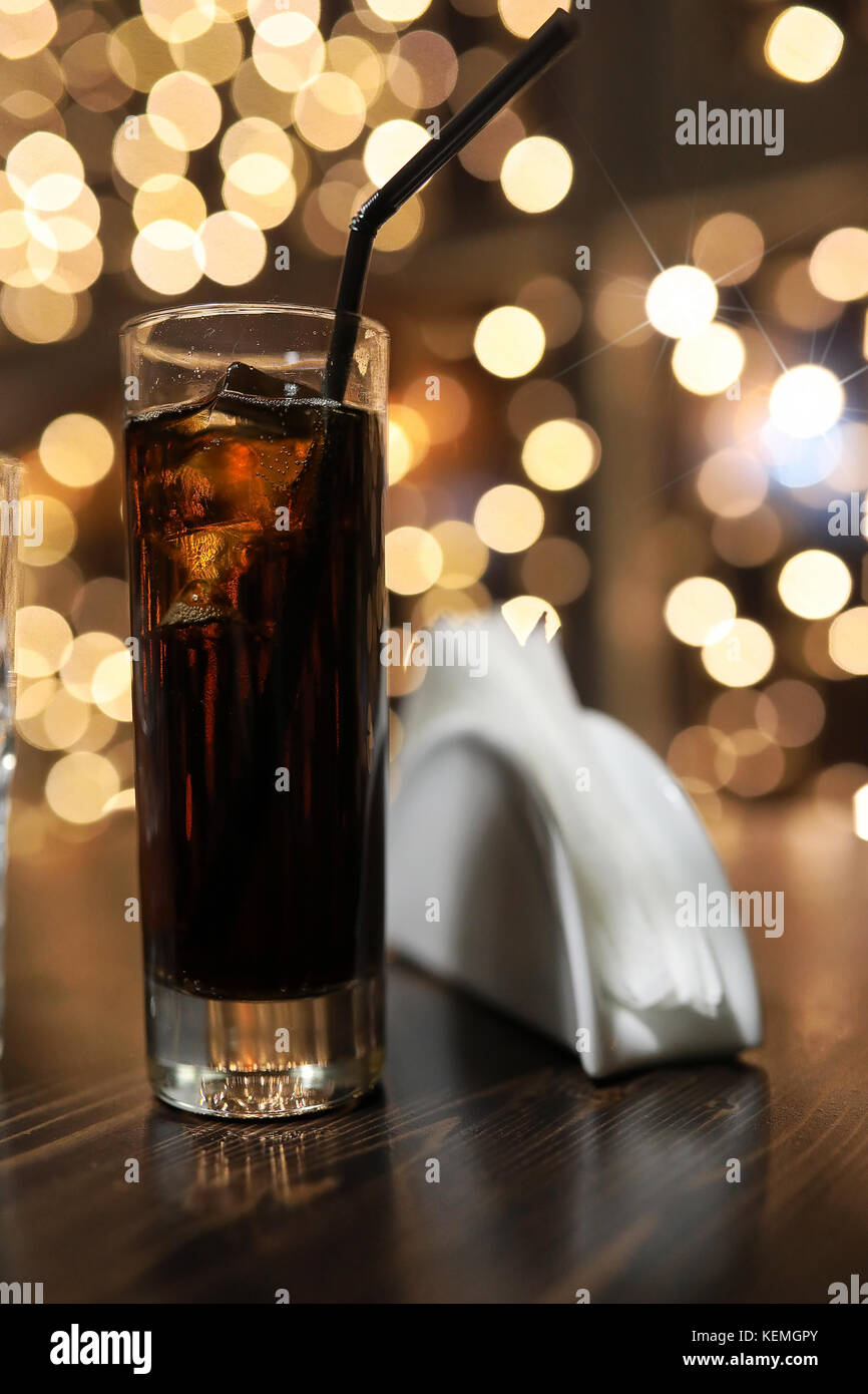 glass of cold alcohol drink with ice on table Stock Photo - Alamy