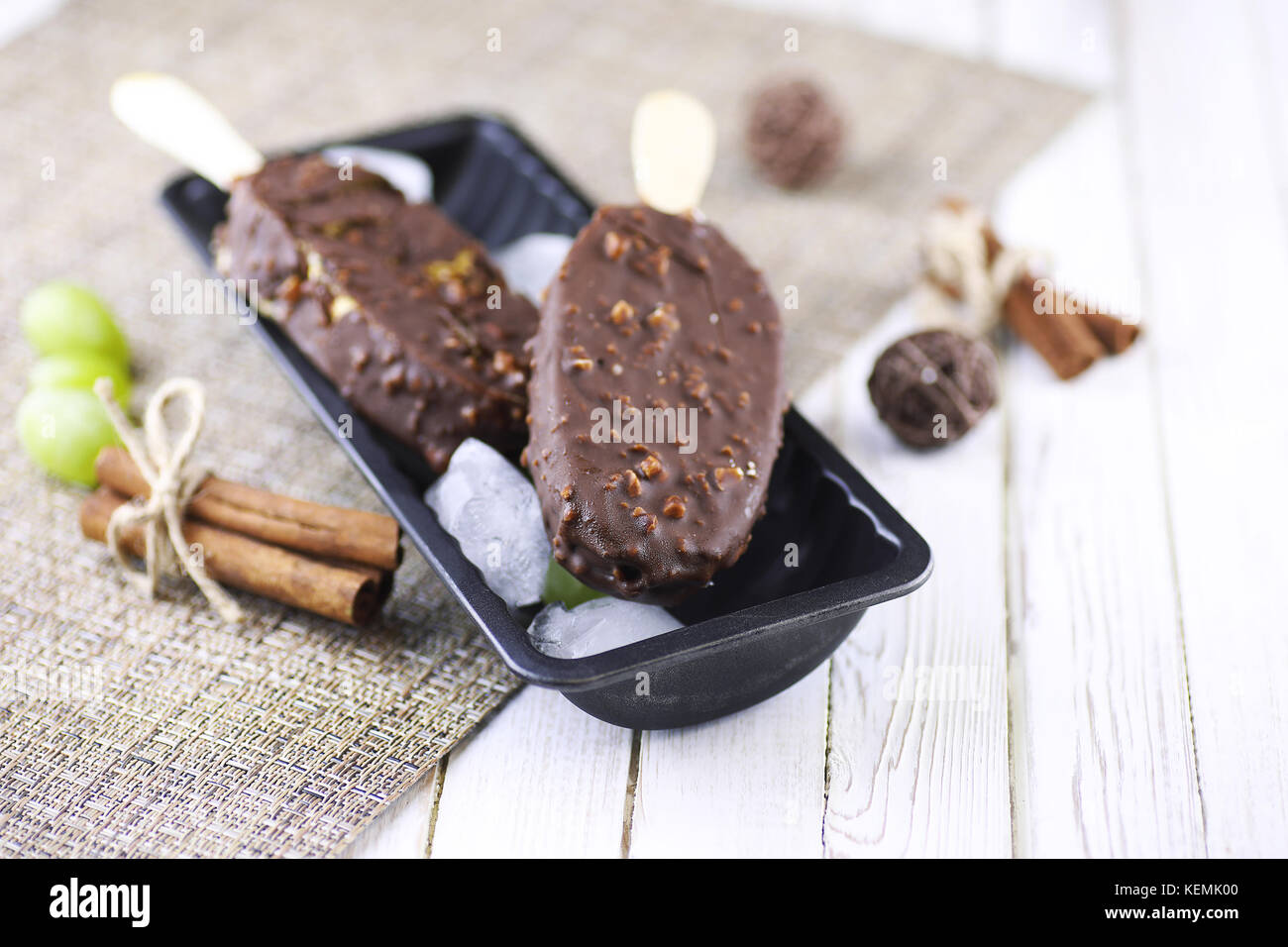Dessert chocolate ice cream with nuts on wooden stick Stock Photo - Alamy
