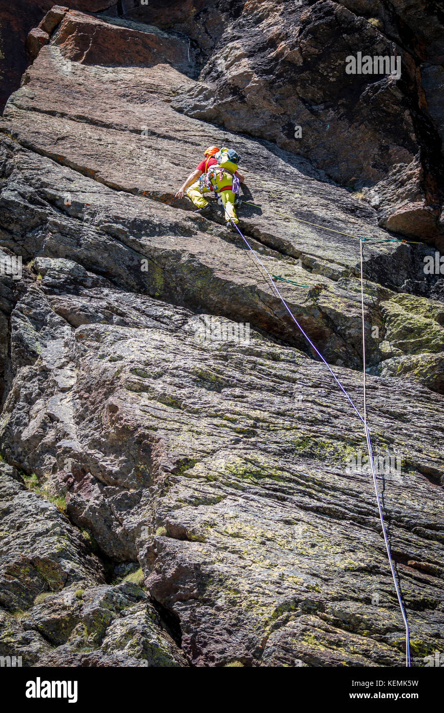 From below panoramic view of man climbing high on mountain Stock Photo ...