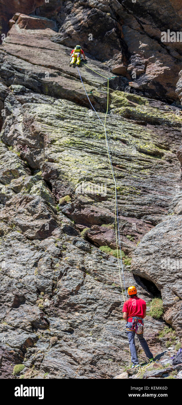 From below panoramic view of man climbing high on mountain Stock Photo ...