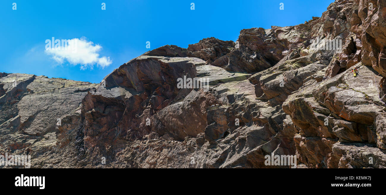 From below panoramic view of man climbing high on mountain Stock Photo ...