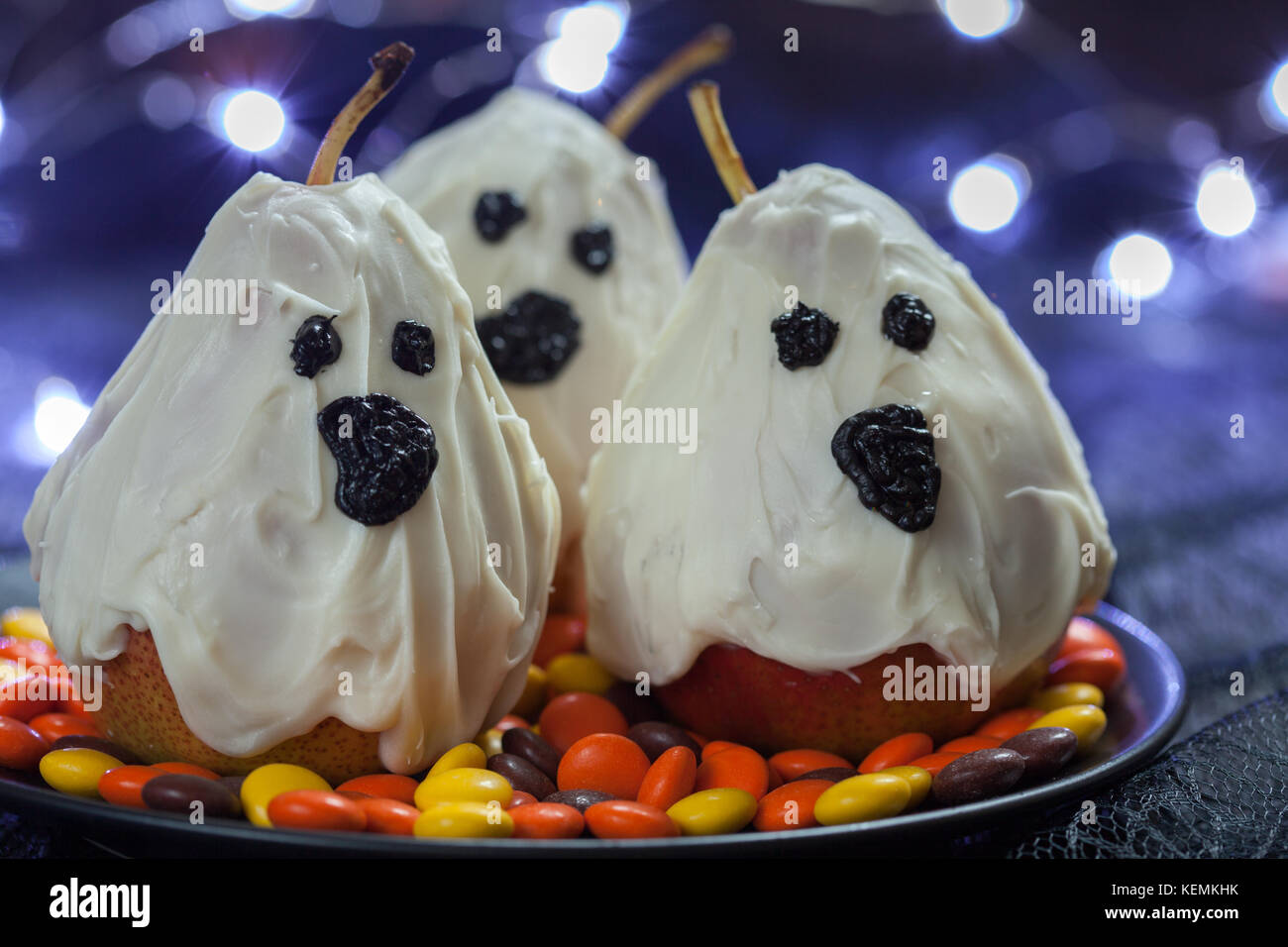Three homemade creative Halloween candy pears or white chocolate ghosts ...