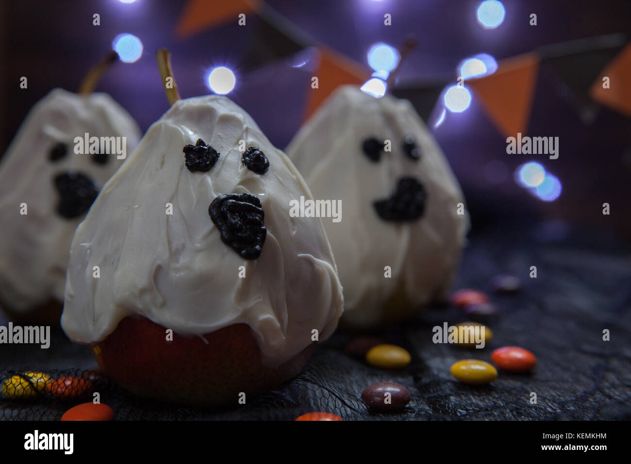 Three homemade creative Halloween candy pears or white chocolate ghosts ...