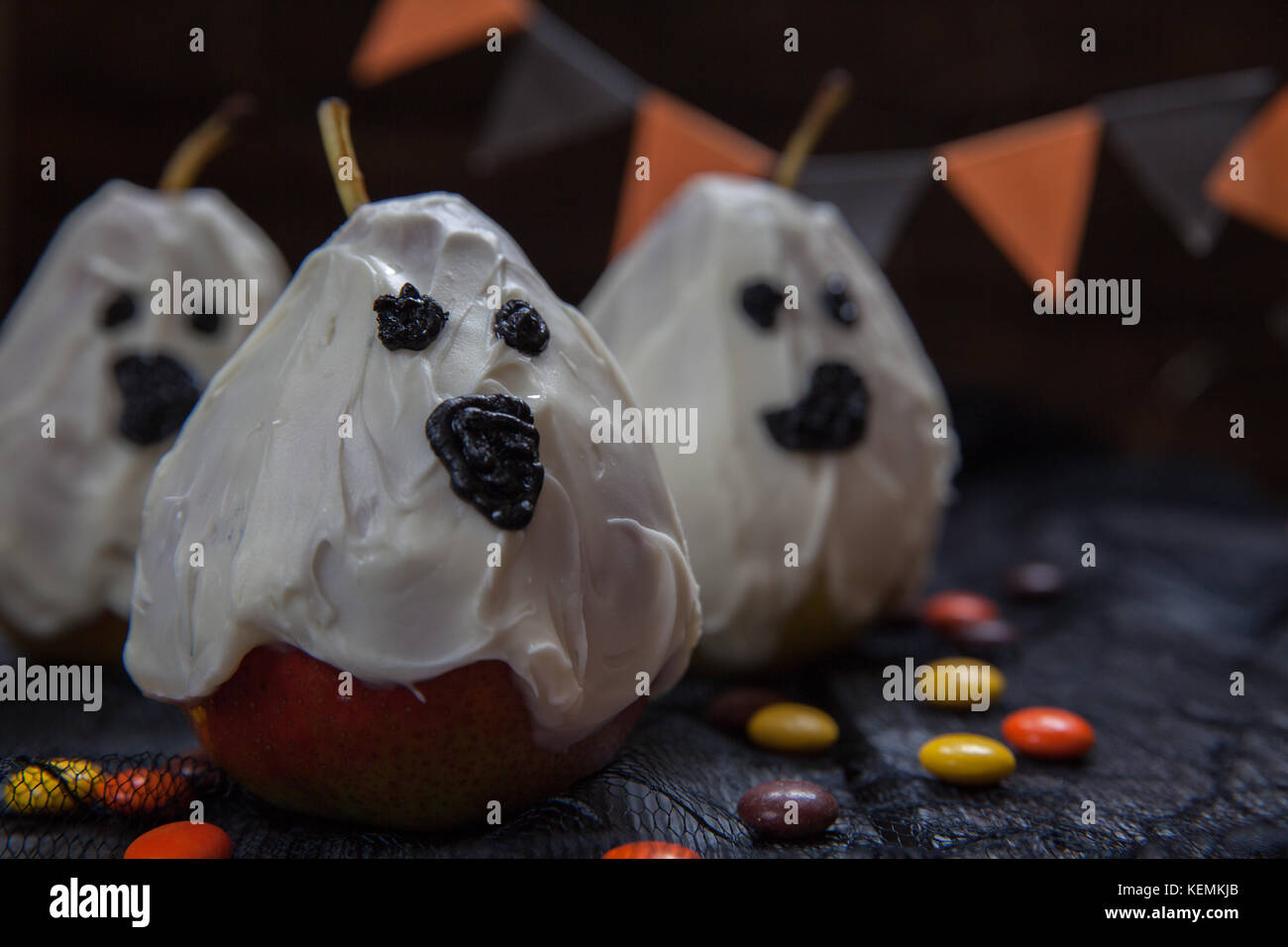 Three homemade creative Halloween candy pears or white chocolate ghosts ...