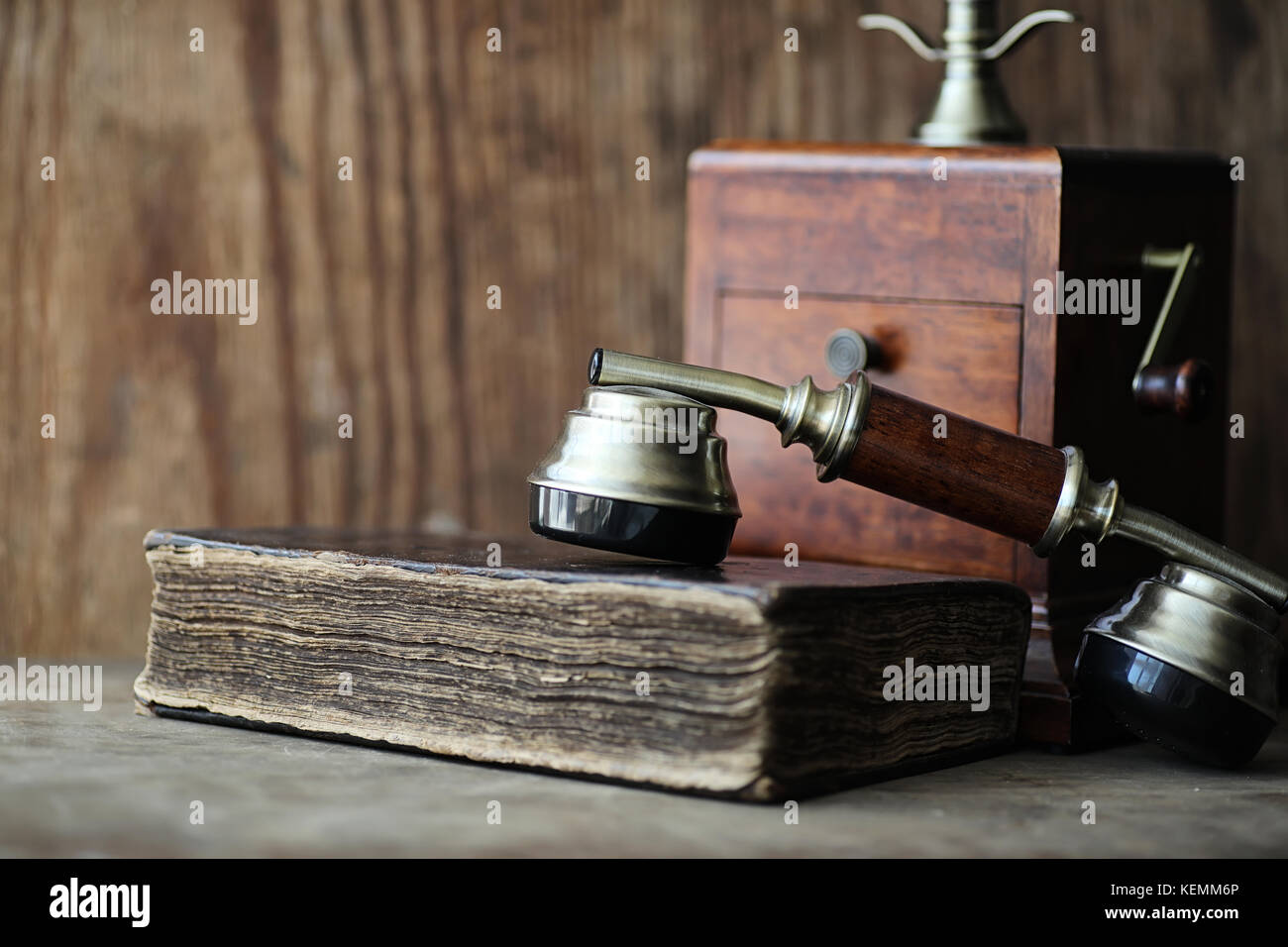 Old telephone and retro book on a wood Stock Photo - Alamy