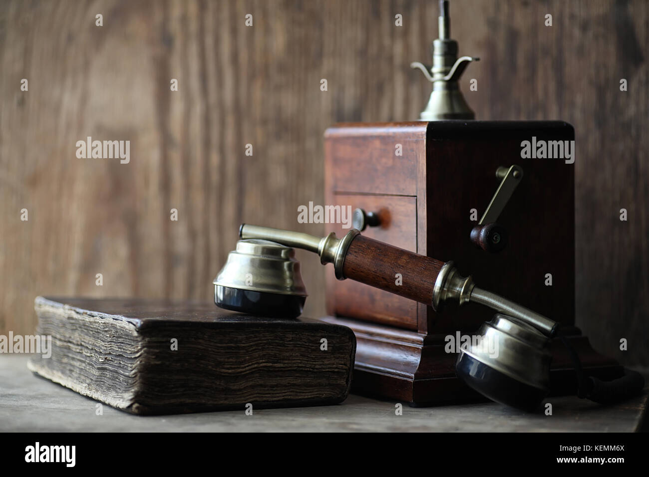 Old telephone and retro book on a wood Stock Photo - Alamy