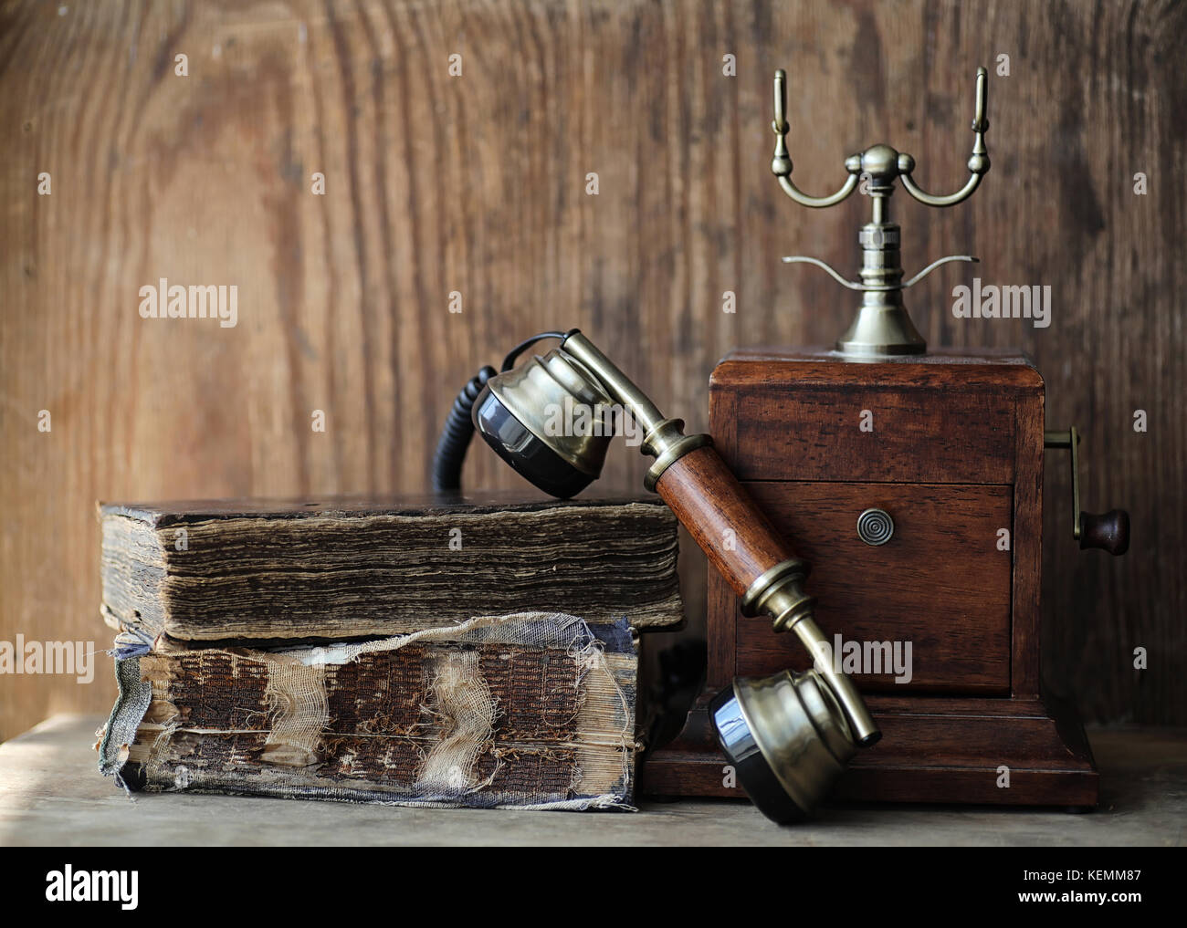 Old telephone and retro book on a wood Stock Photo - Alamy