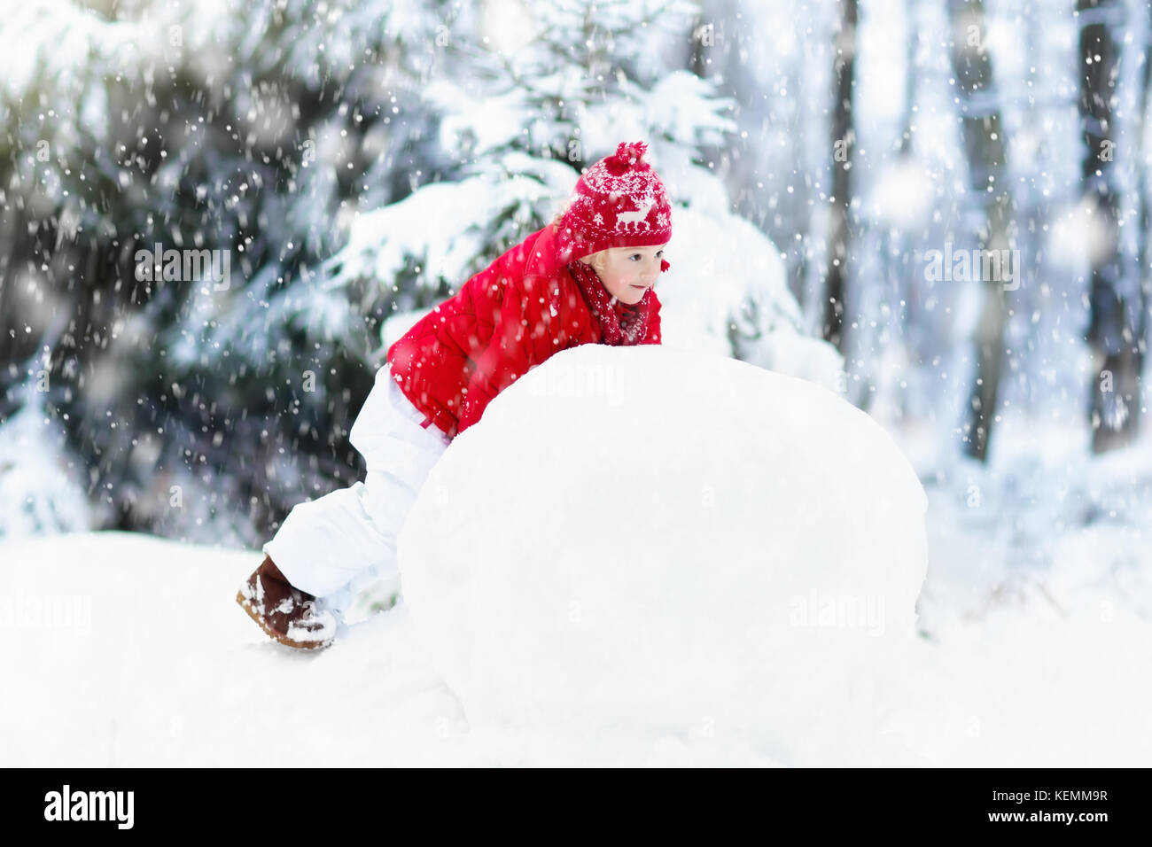 Children build snowman. Kids building snow man playing outdoors on ...