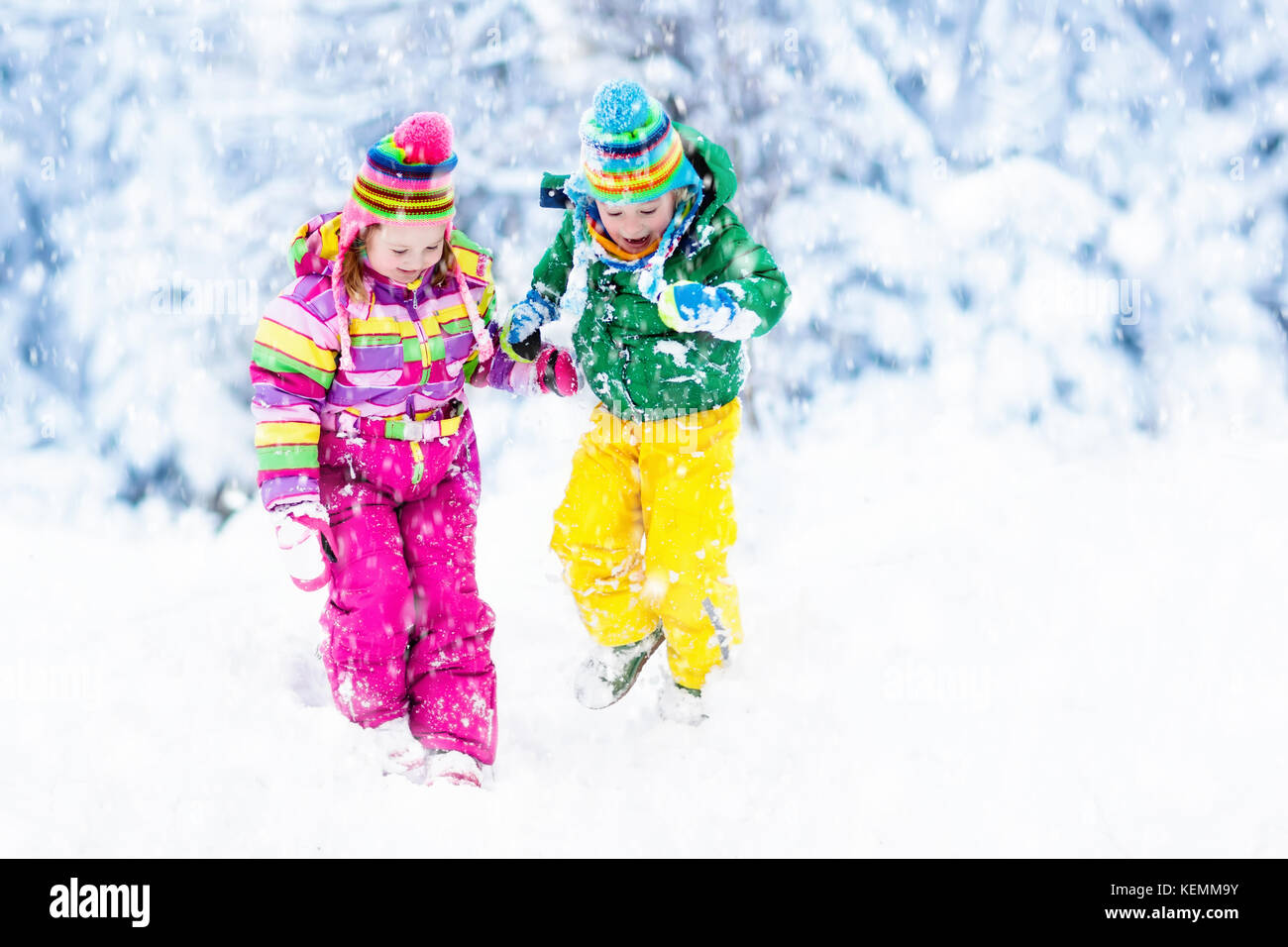 Kids playing in snow. Children play outdoors on snowy winter day. Boy ...