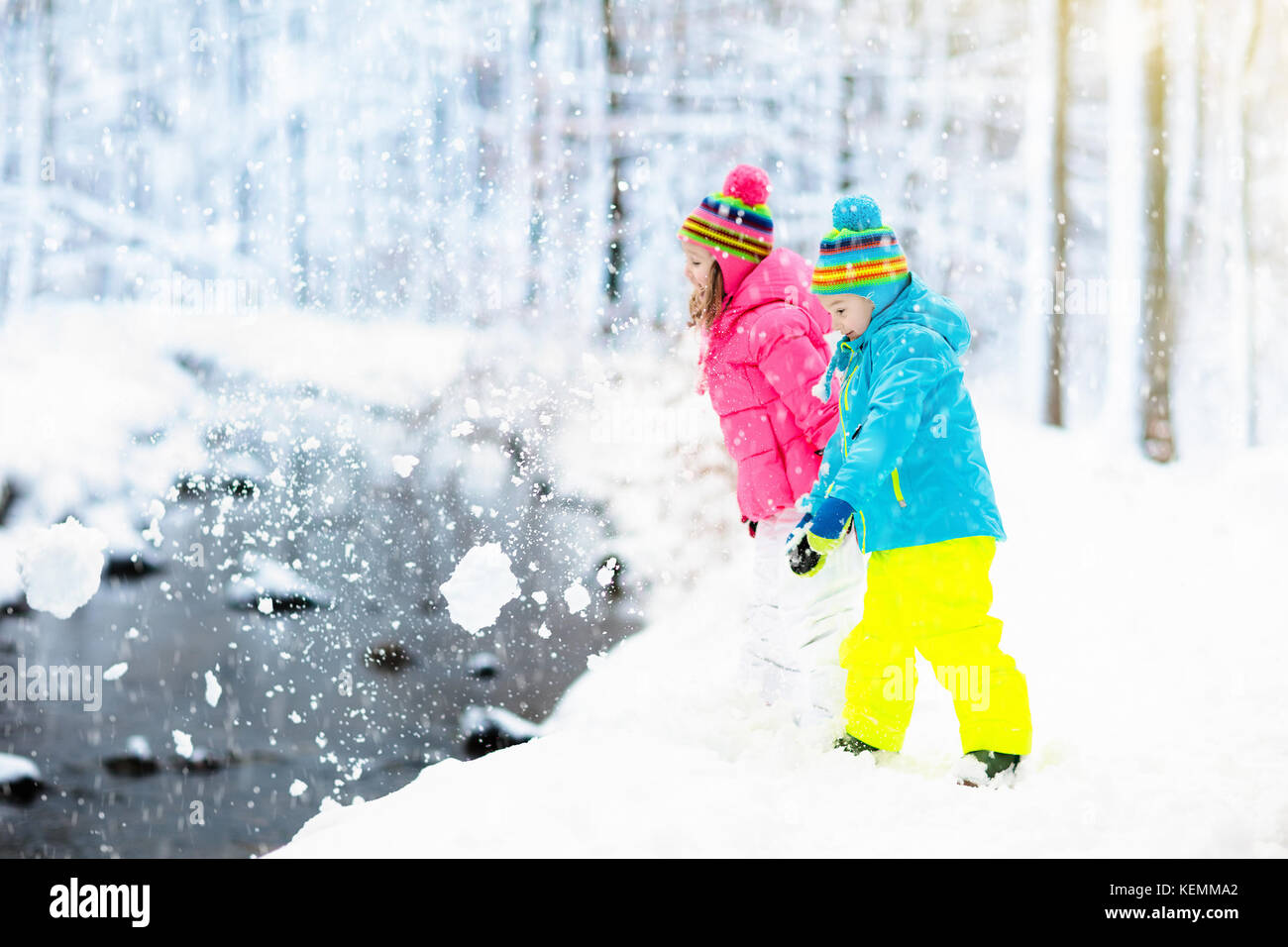 Kids playing in snow. Children play outdoors on snowy winter day. Boy ...