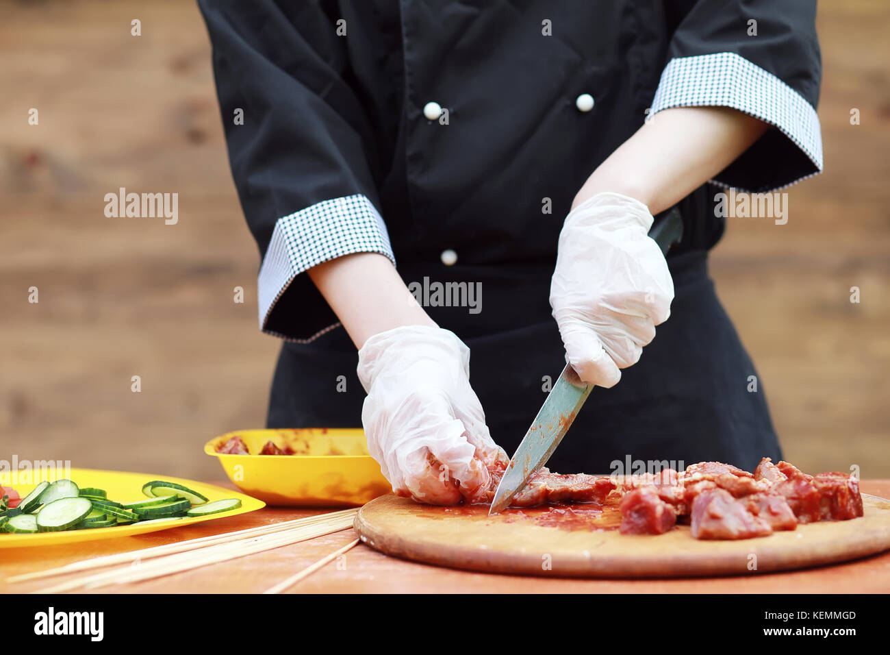 The cook cuts meat for cooking barbecue Stock Photo - Alamy