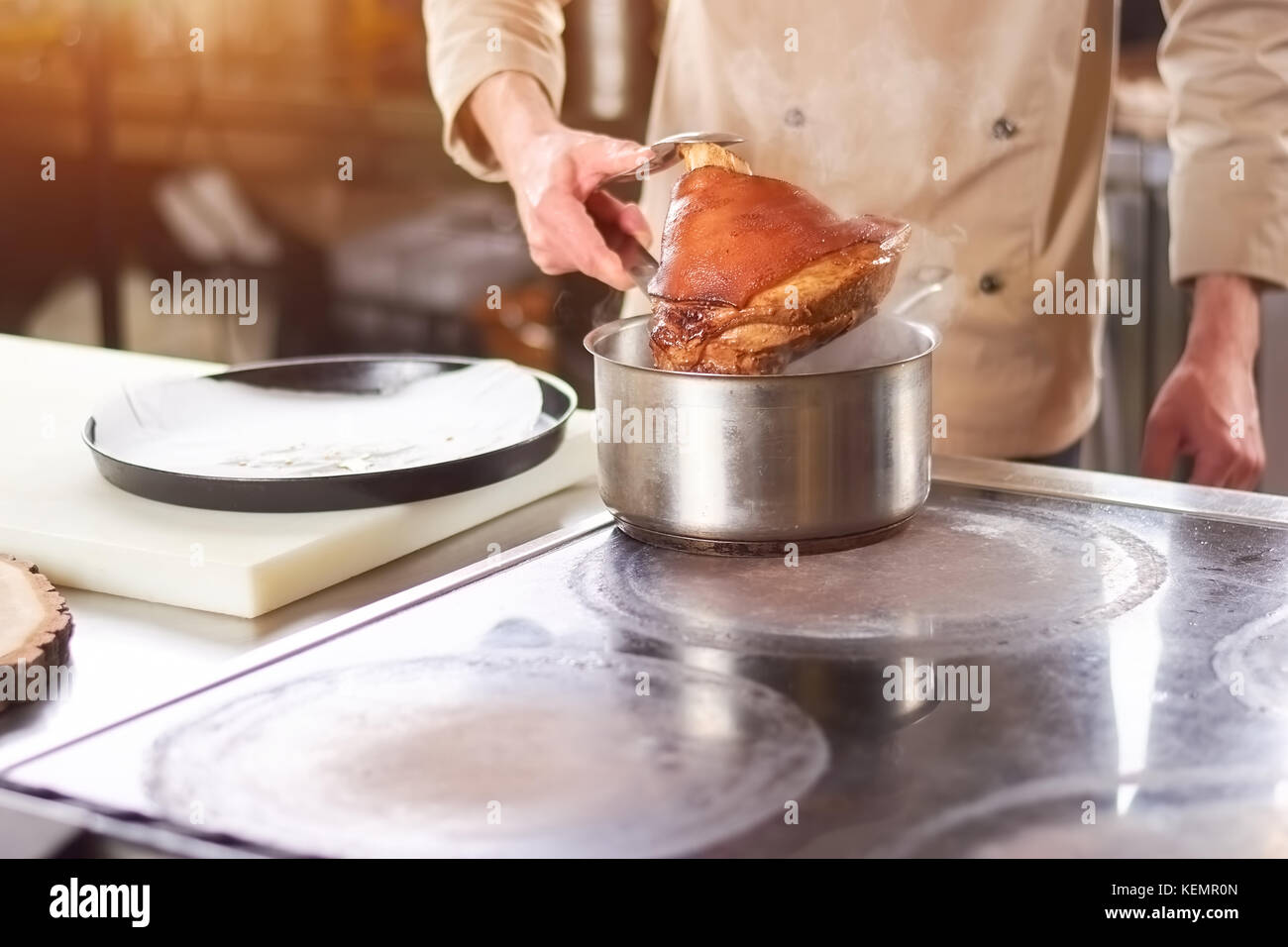Chef holding large piece of lab leg. Male chef at professional kitchen ...