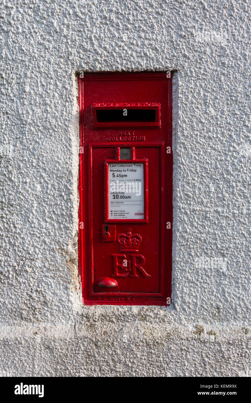 Traditional British red Royal Mail wall mounted post box surrounded by ...