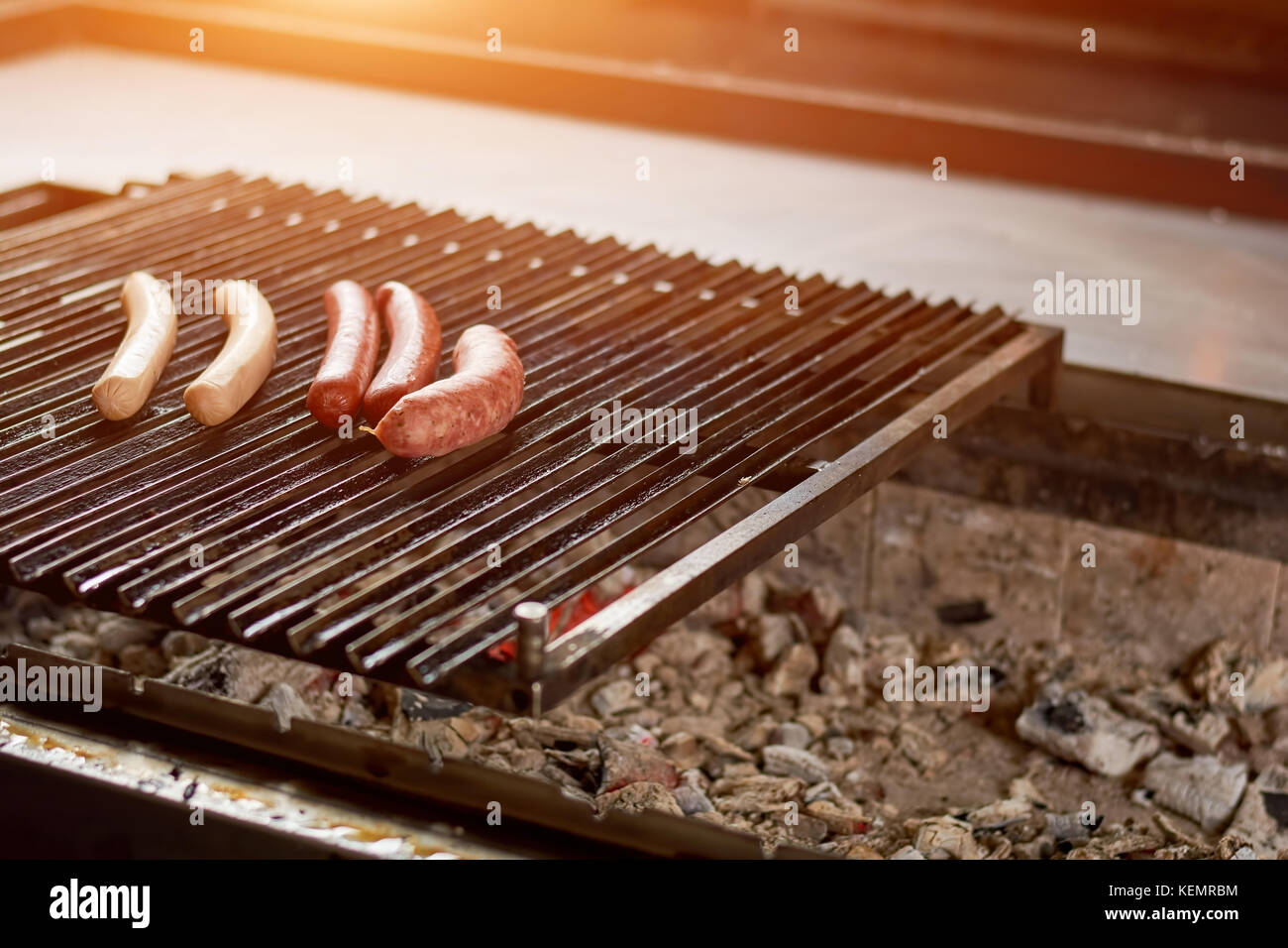 Cook putting sausages on grill hi-res stock photography and images - Alamy