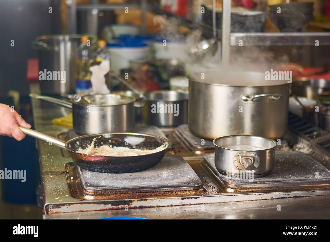 Man cooking at commercial kitchen. Man preparing food at residence ...