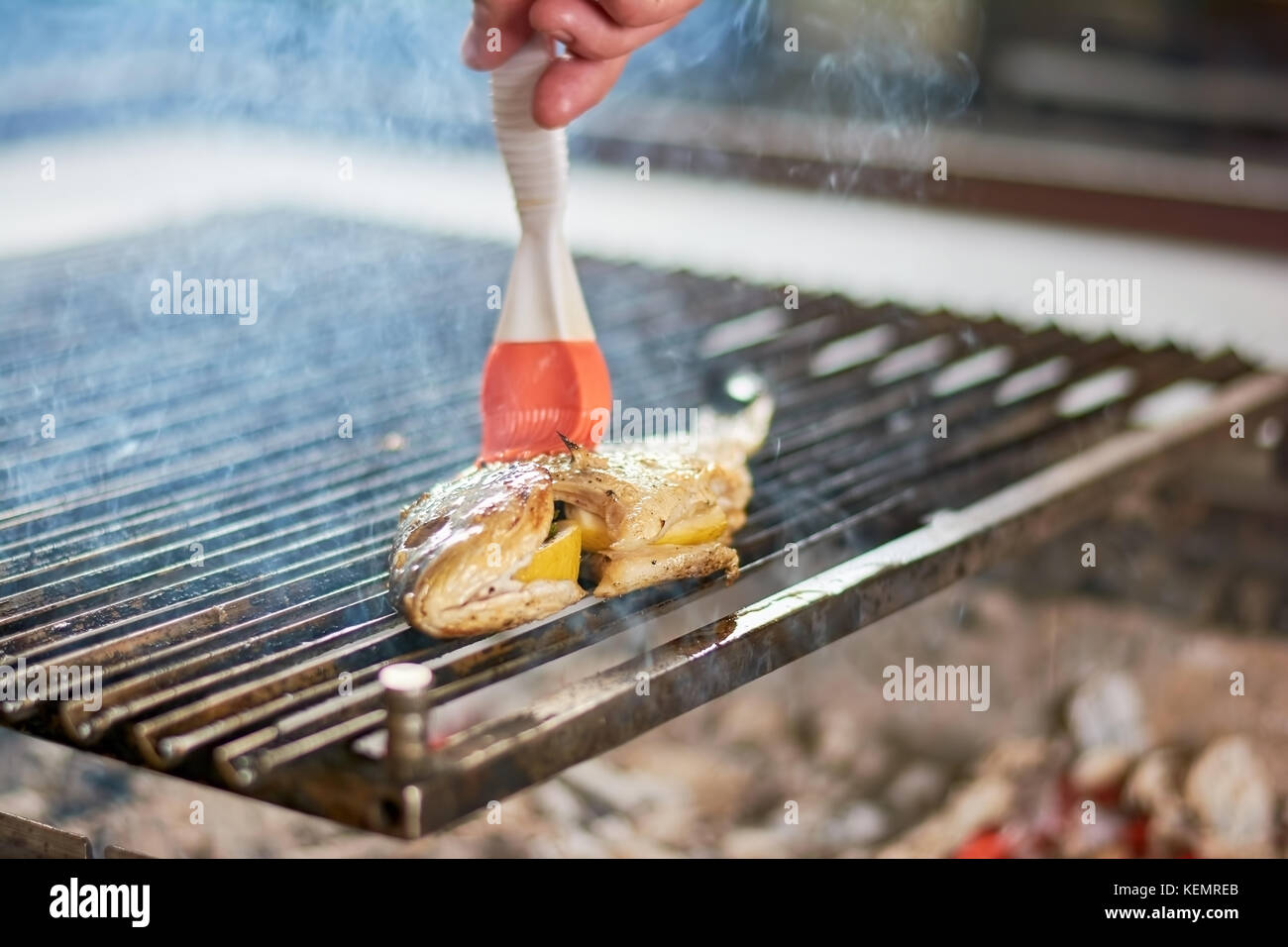 Chef cooking dorado fish on grill. Male hand grilling on grill fish ...