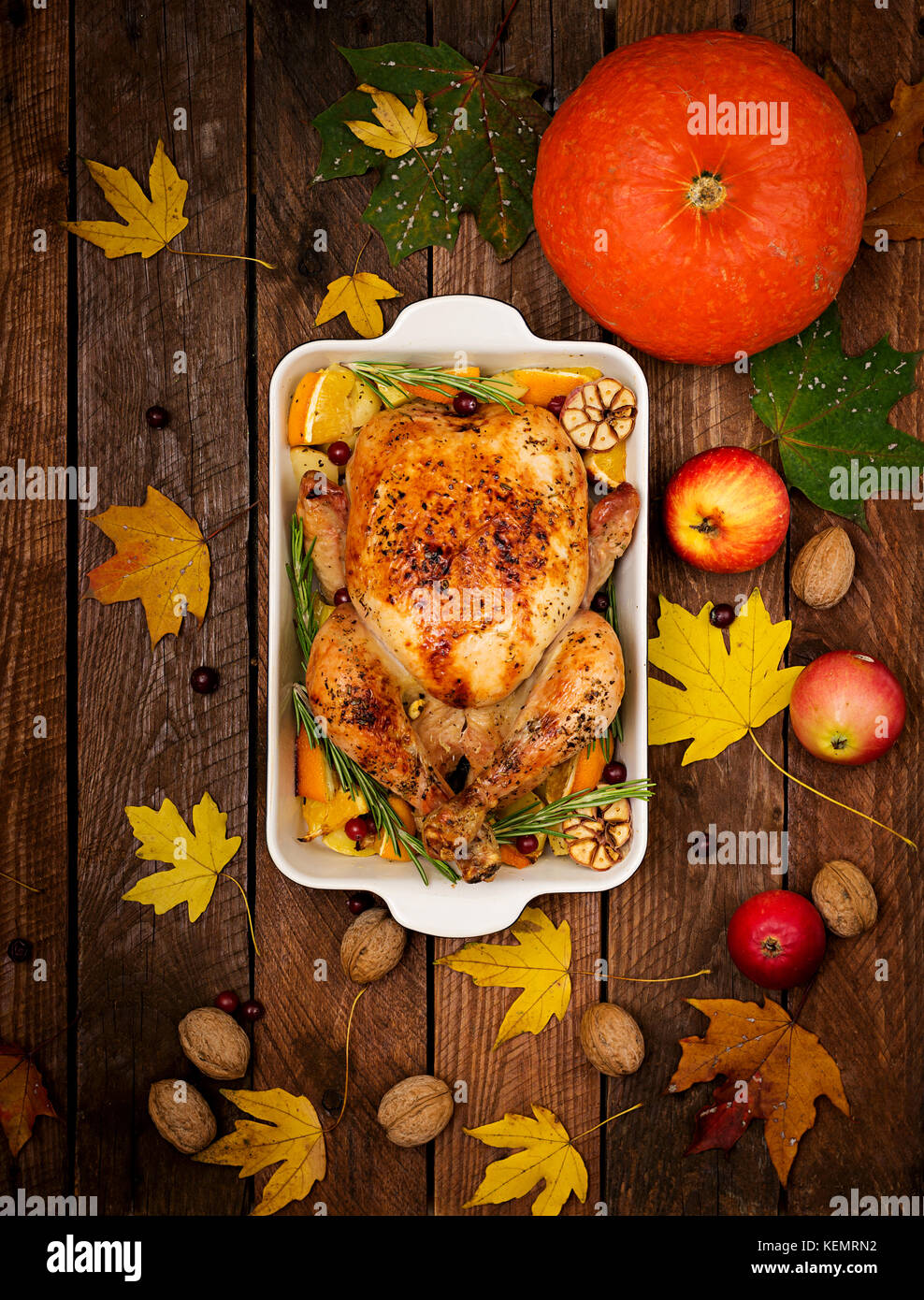 Roasted turkey garnished with cranberries on a rustic style table ...