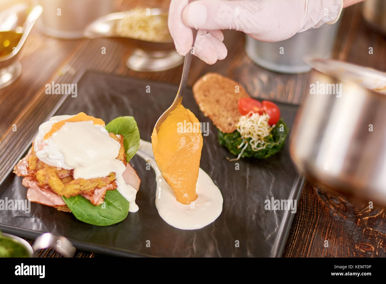Cooking delicious benedict in restaurant. Chef hand serving tasty ...
