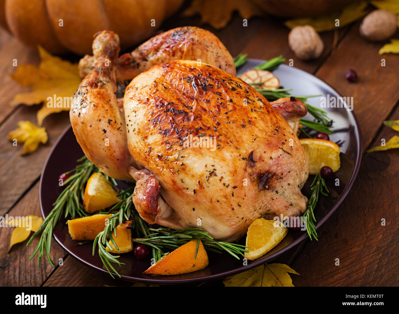 Roasted turkey garnished with cranberries on a rustic style table ...