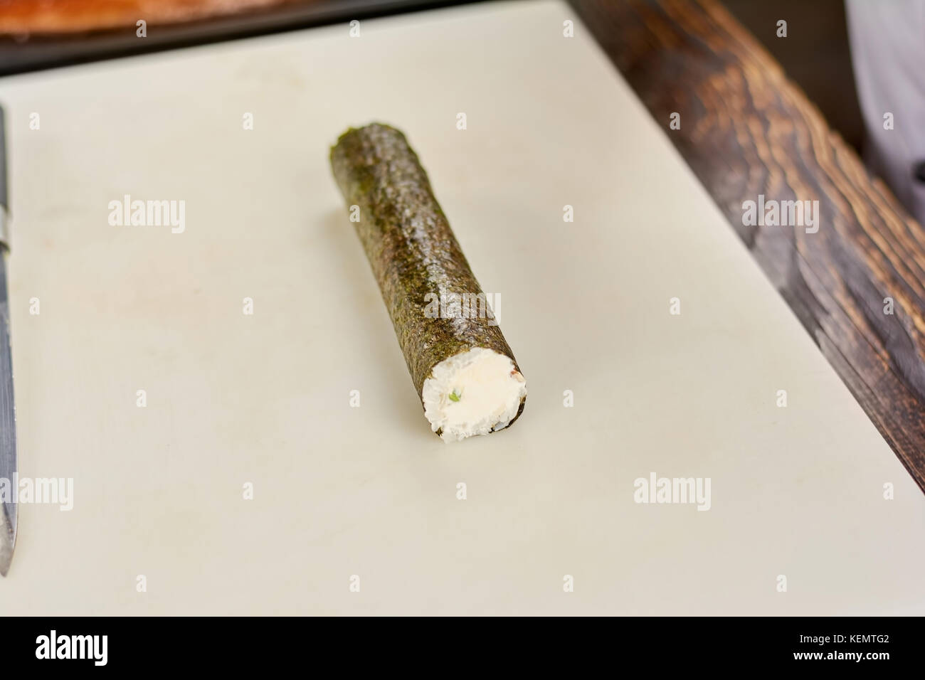 Long sushi roll with rice and nori. Sushi preparation at japanese ...