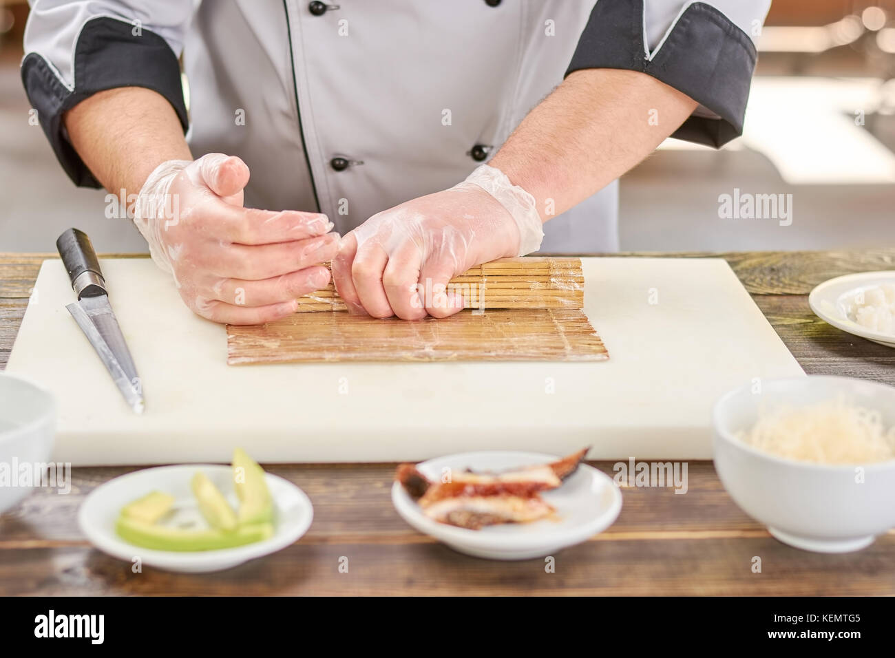 Chef hands shaping sushi roll. Male cook hands making japanese sushi ...
