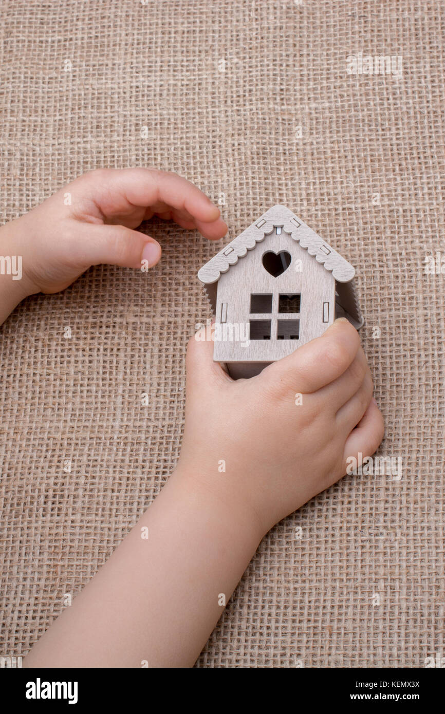 Child holding a model house on a linen canvas Stock Photo - Alamy