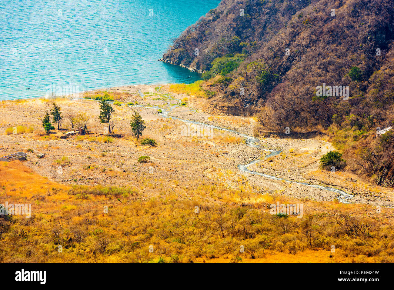 Aerial view of a river flowing into Lake Atitlan during dry season ...