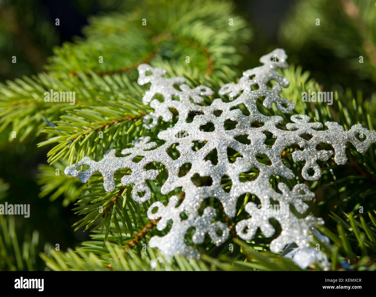 Glitter snowflake Christmas decoration on a tree Stock Photo - Alamy