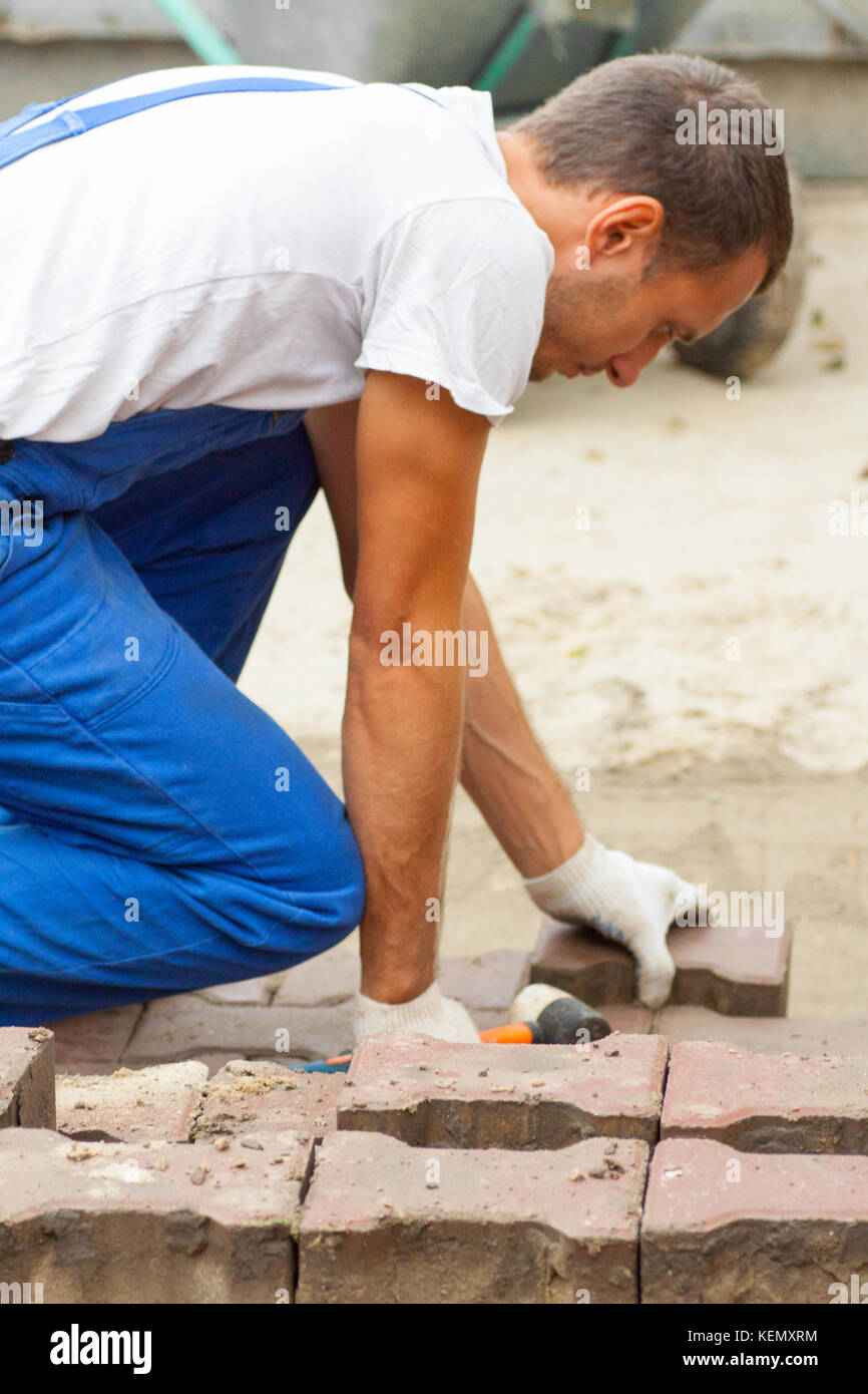 the master paves the paving slab professionally Stock Photo - Alamy