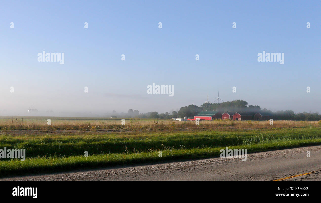 Rural landscape with barns trees and wind turbines in Southern Ontario ...
