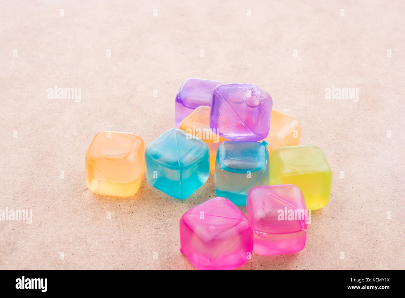 Fake colorful ice cubes on a brown background Stock Photo - Alamy
